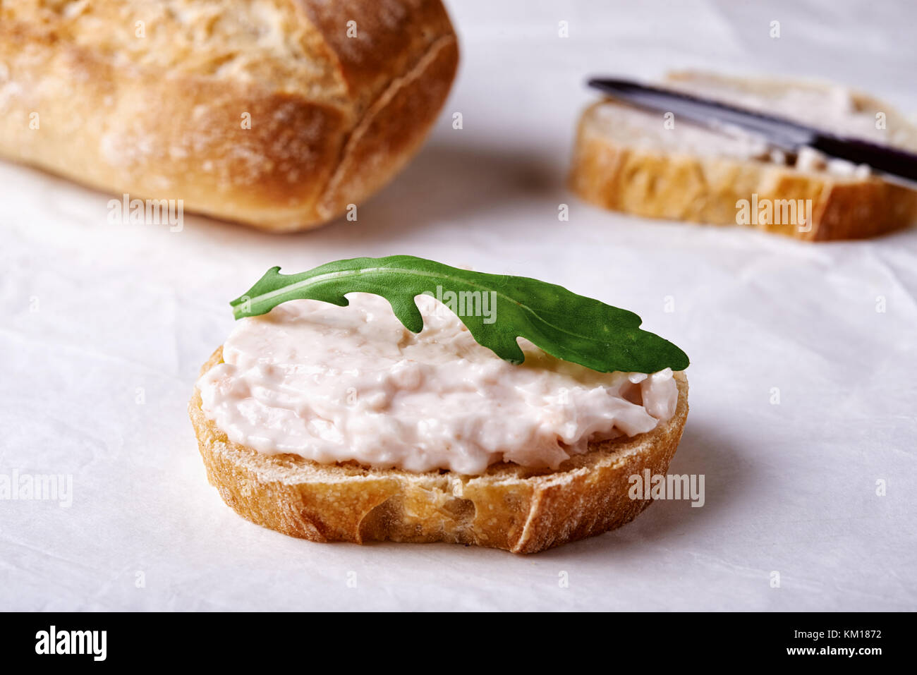slices of bread with fish spread on white background Stock Photo - Alamy