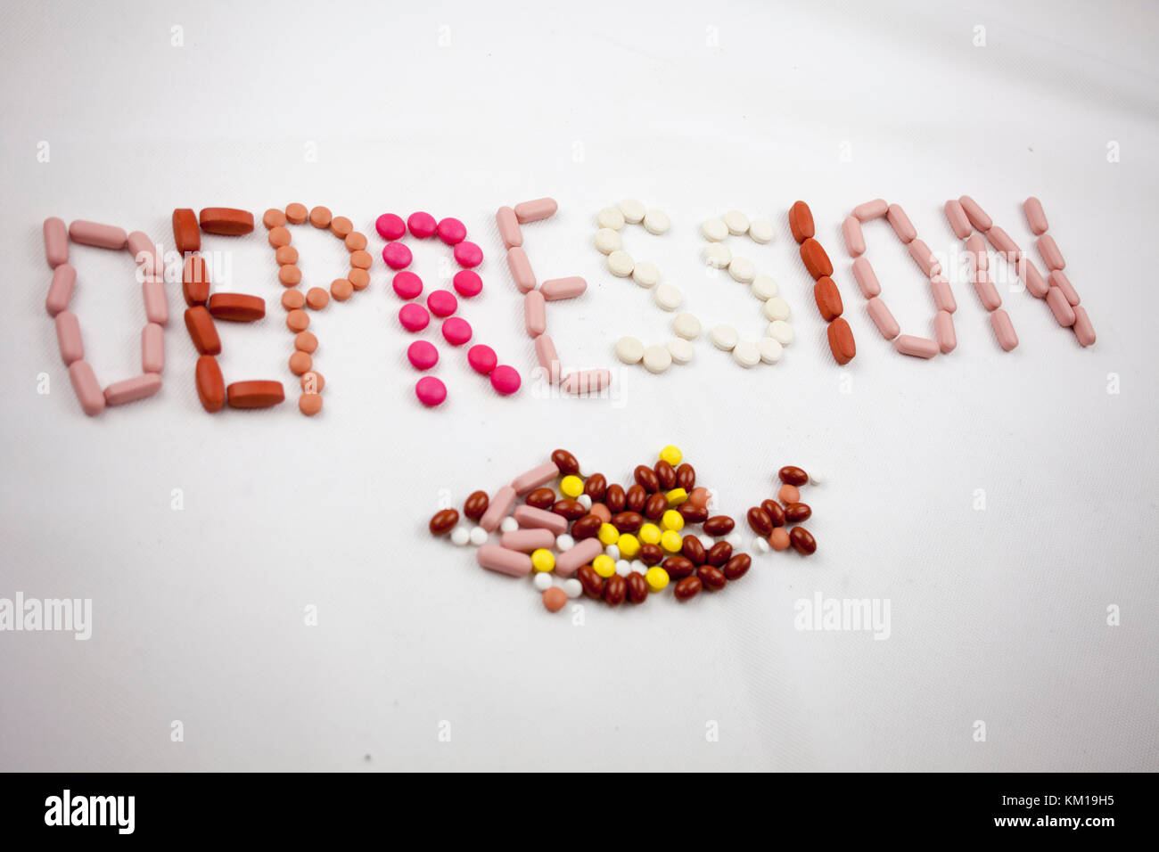 A depression word, writing on the white background on pills with copy ...