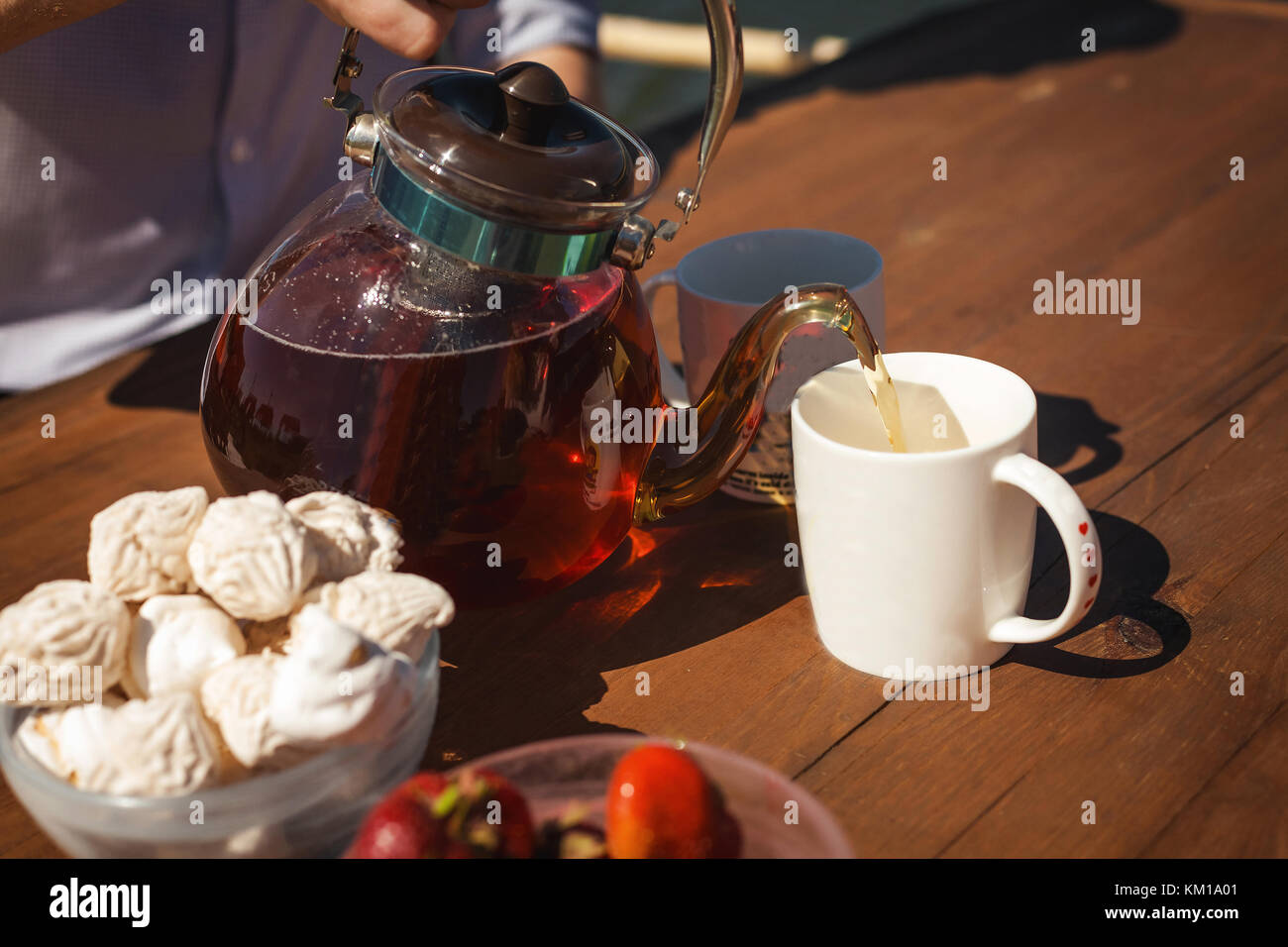 boy and girl resting and drinking tea near lake Stock Photo - Alamy