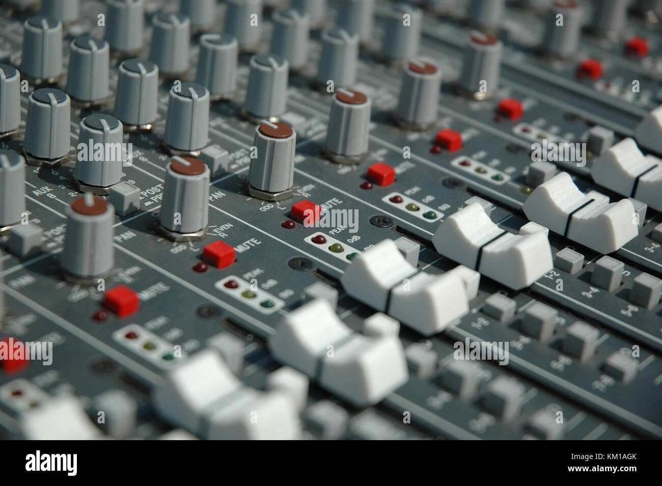 Audio mixing console in a recording studio. Faders and knobs of a sound ...