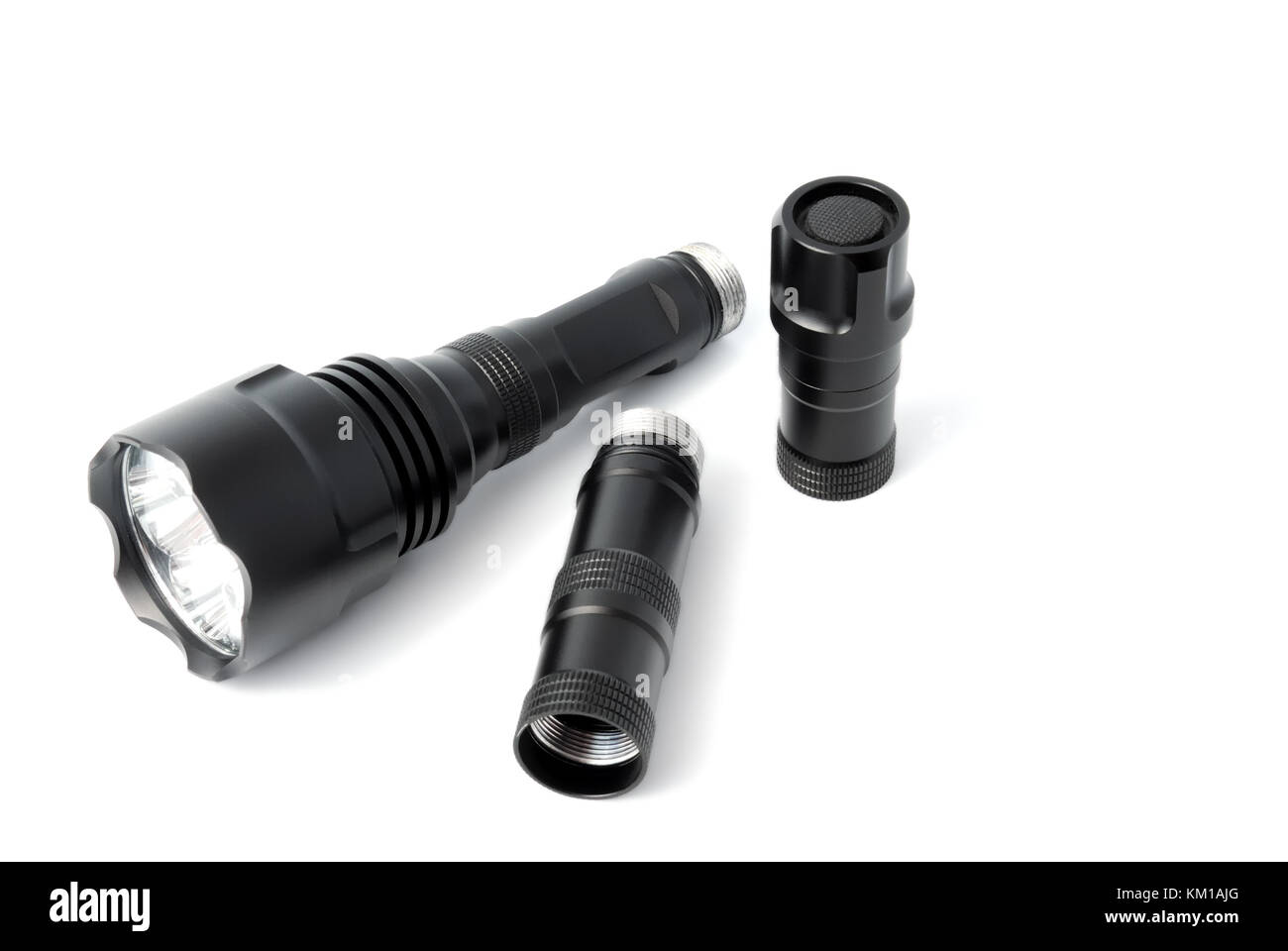 A black metal coated flashlight isolated on white Stock Photo - Alamy