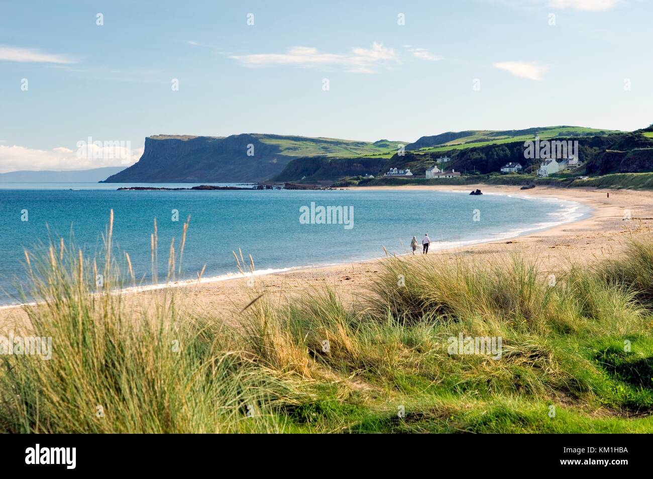 Middle age couple walking on Ballycastle Beach, County Antrim, Northern ...