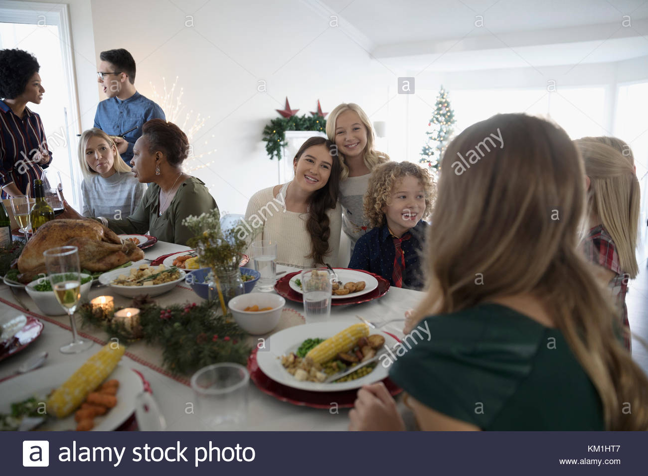 Family enjoying Christmas dinner at table Stock Photo - Alamy