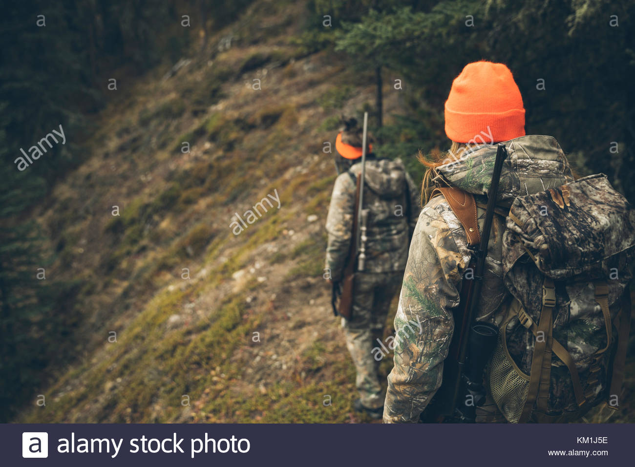 Woman with rifle walking away hi-res stock photography and images - Alamy