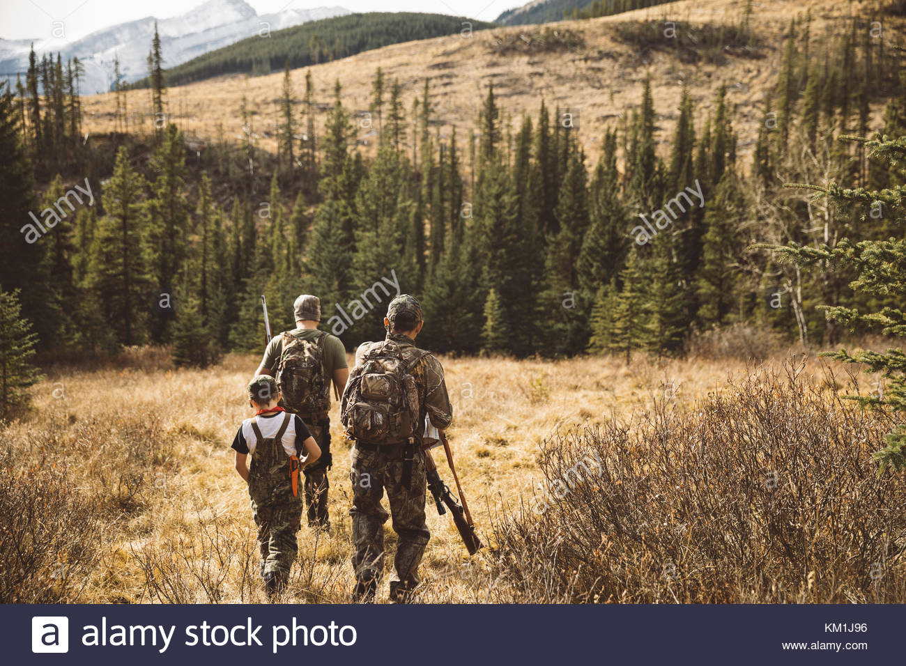 Rear view man holding gun hi-res stock photography and images - Alamy