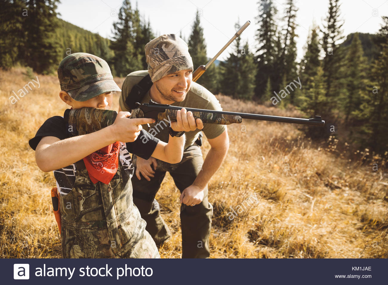 Father and son shooting together hi-res stock photography and images ...
