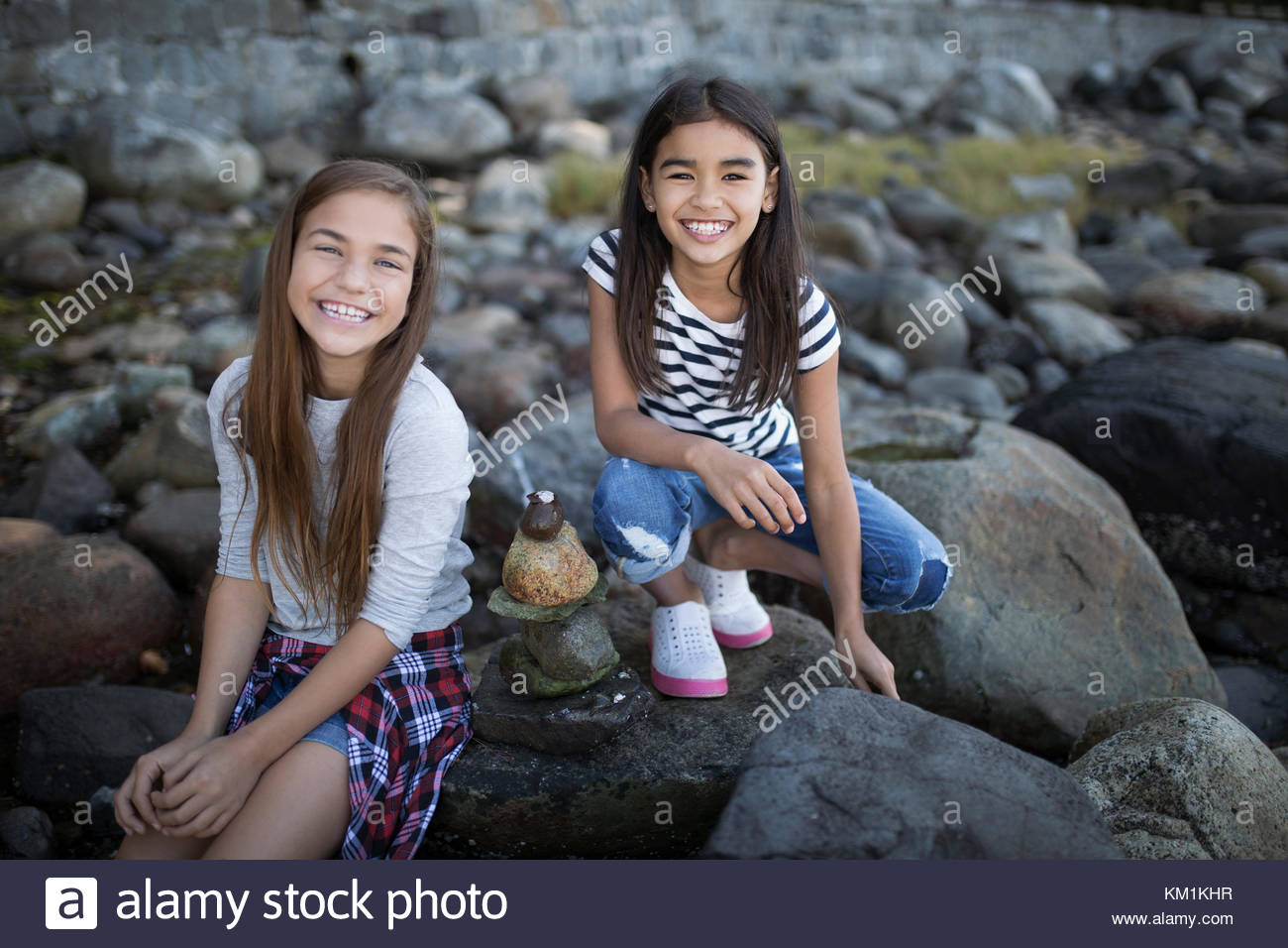 Child stacking rocks hi-res stock photography and images - Alamy