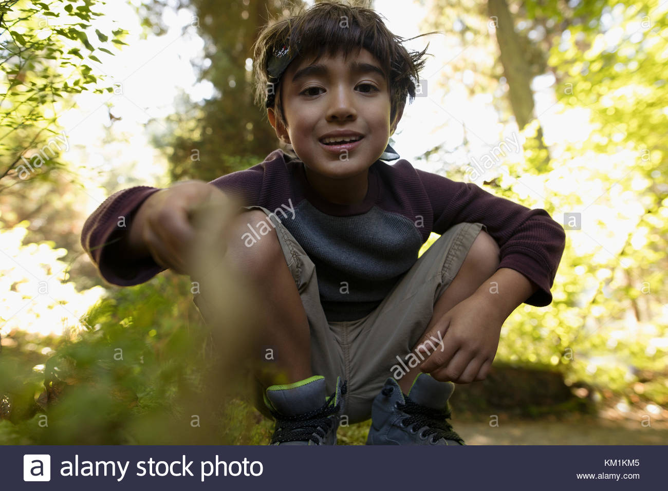 Boy playing in woods hi-res stock photography and images - Alamy