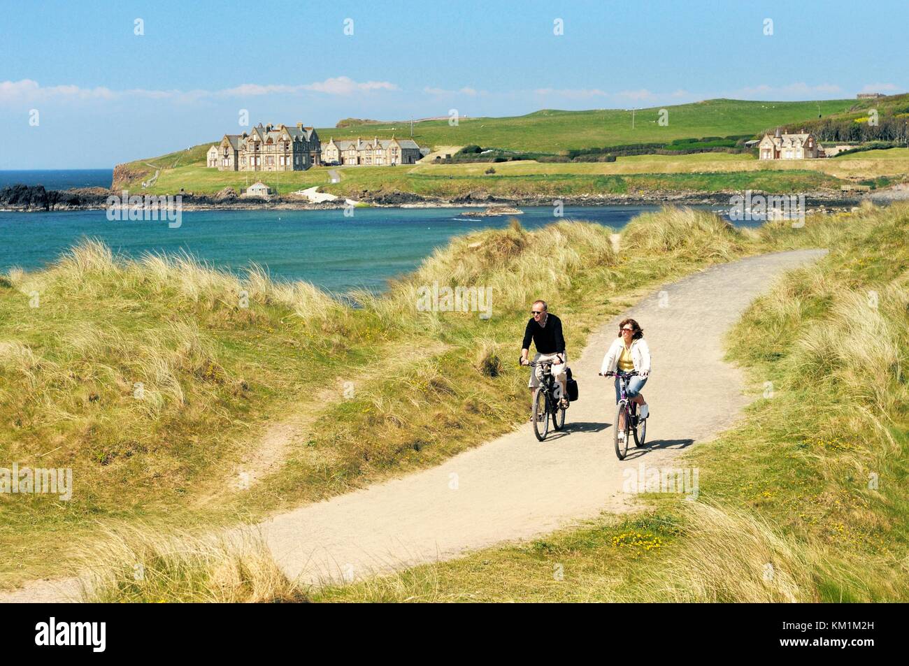 Cycling in sand dunes of Runkerry Strand, Portballintrae near Bushmills ...