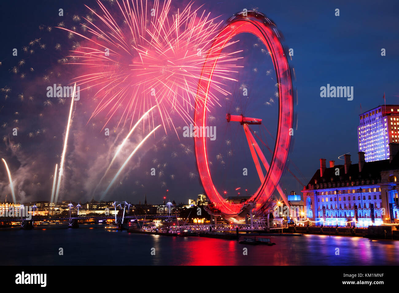 explosive fireworks display fills the sky around London eye. New Year's ...