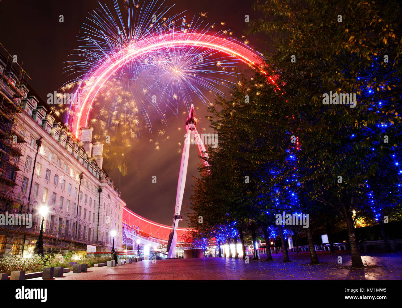explosive fireworks display fills the sky around London eye. New Year's ...