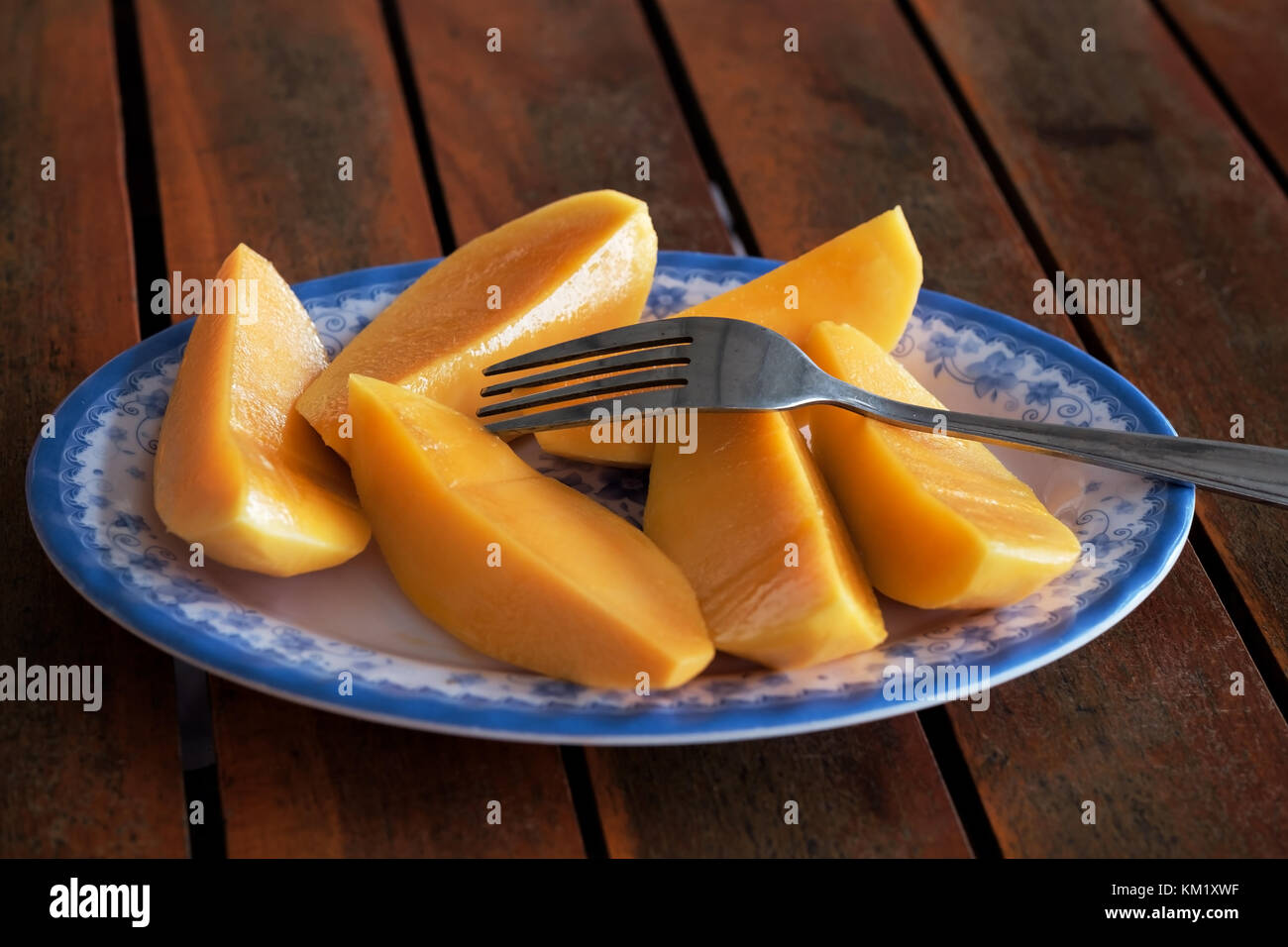 fresh ripe mango on a plate Stock Photo - Alamy