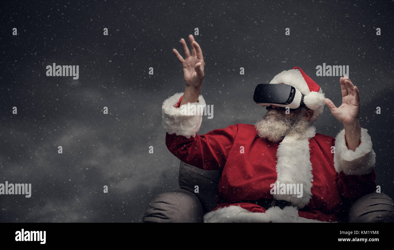 Santa Claus experiencing virtual reality surrounded by snow falling, he ...