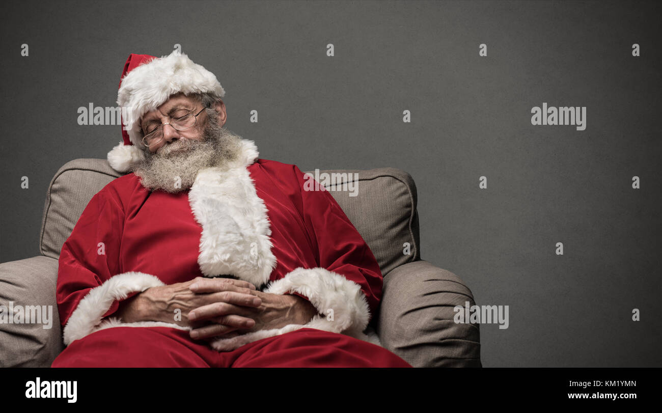 Sleepy Santa Claus taking a nap and relaxing on the armchair on ...