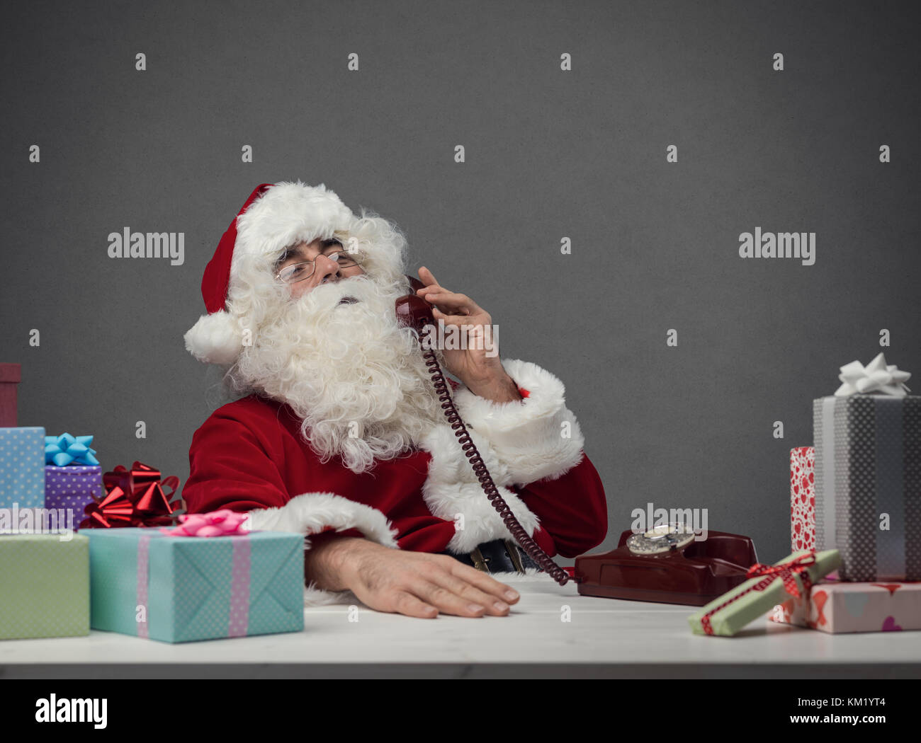 Serene Santa Claus answering phone calls on Christmas Eve and preparing ...