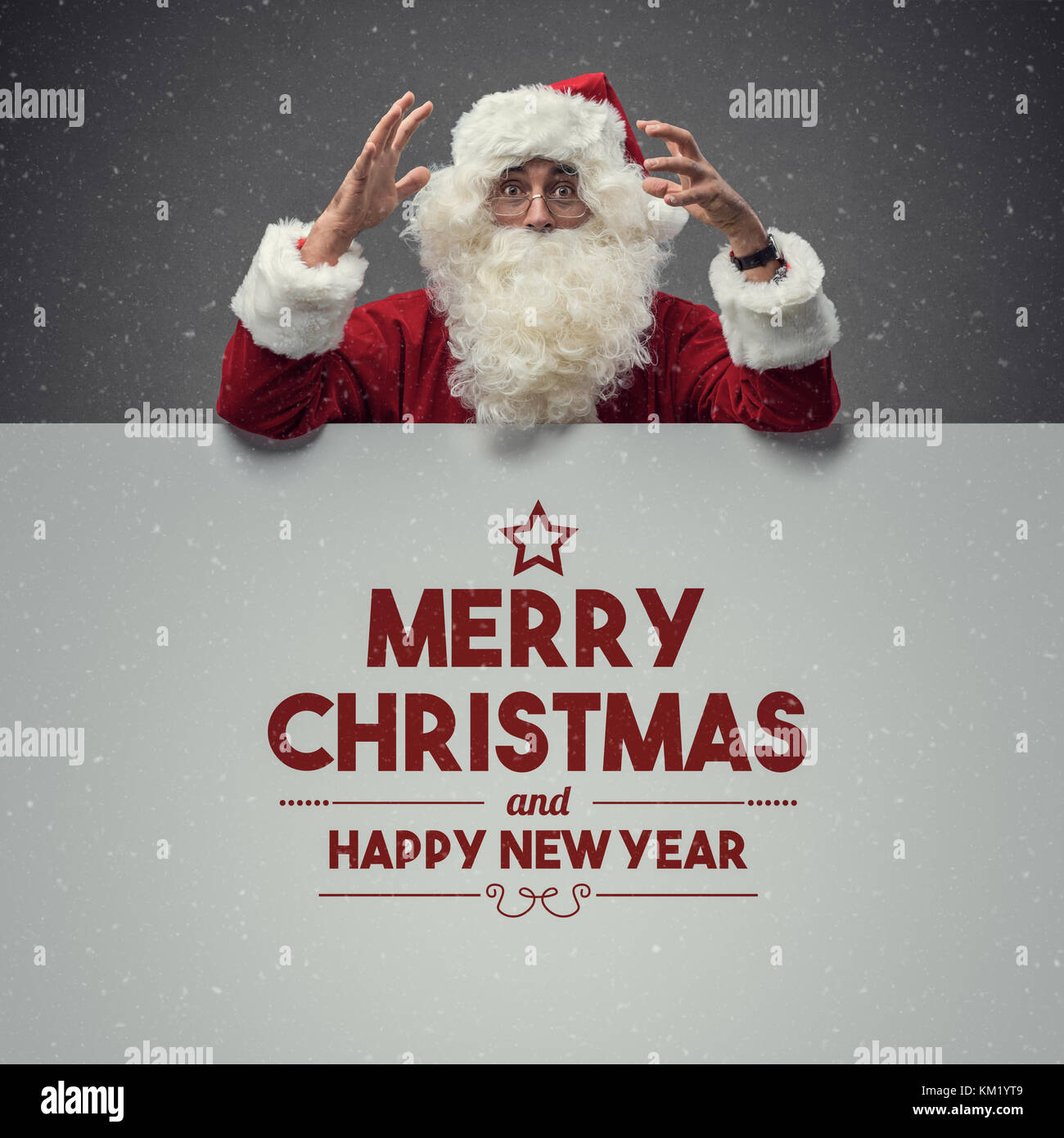 Cheerful happy Santa Claus wishing a joyful merry Christmas and snow ...