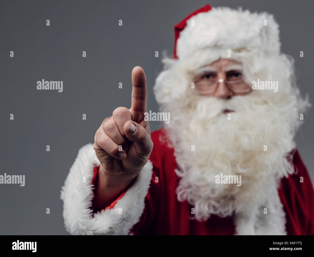 Santa Claus using an interactive touch screen user interface, he is ...