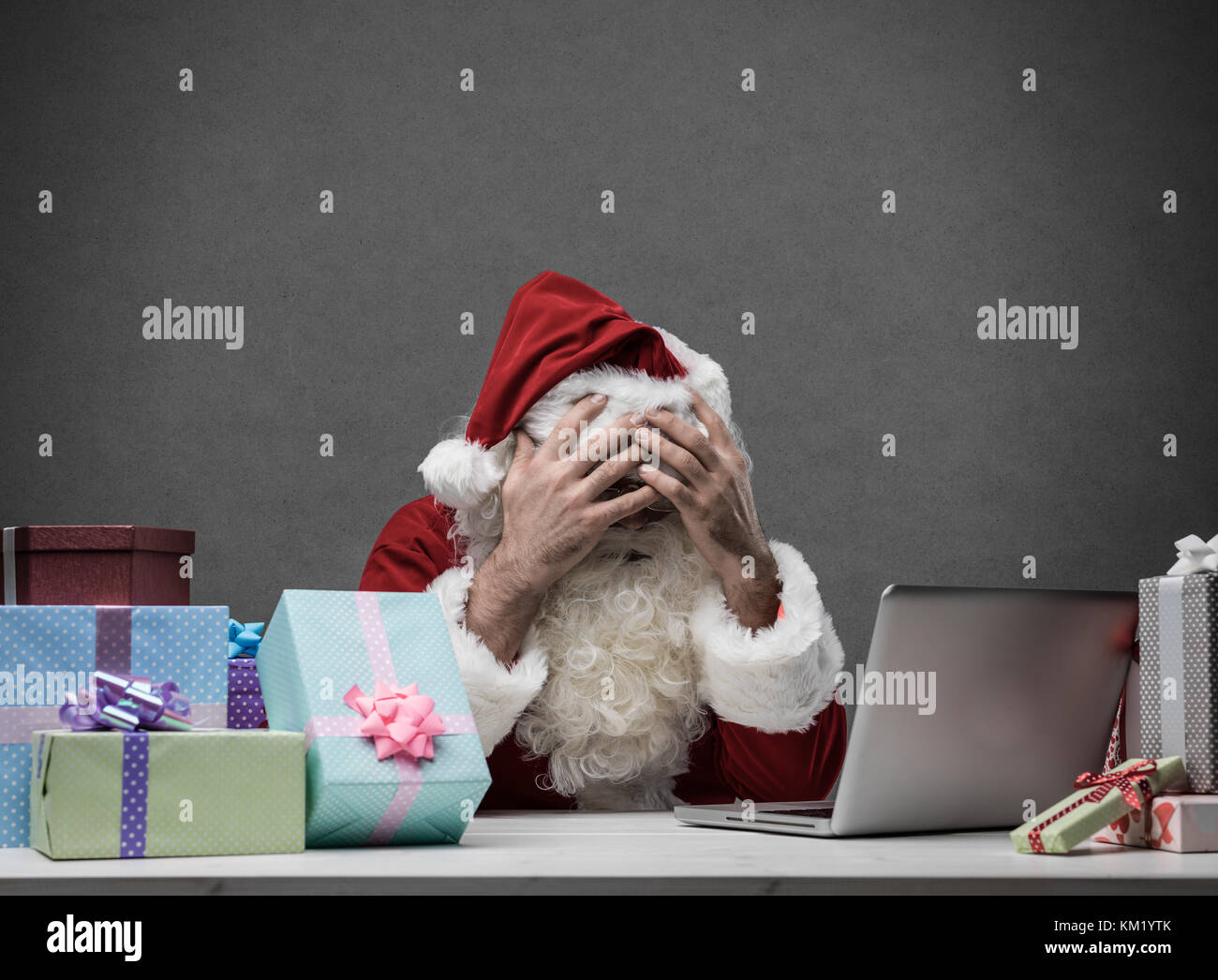 Stressed frustrated Santa Claus with head in hands connecting with his ...