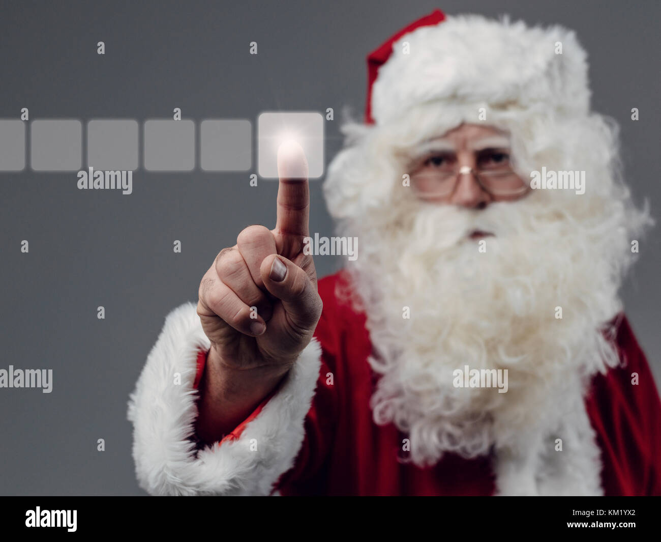 Santa Claus using an interactive touch screen user interface, he is ...