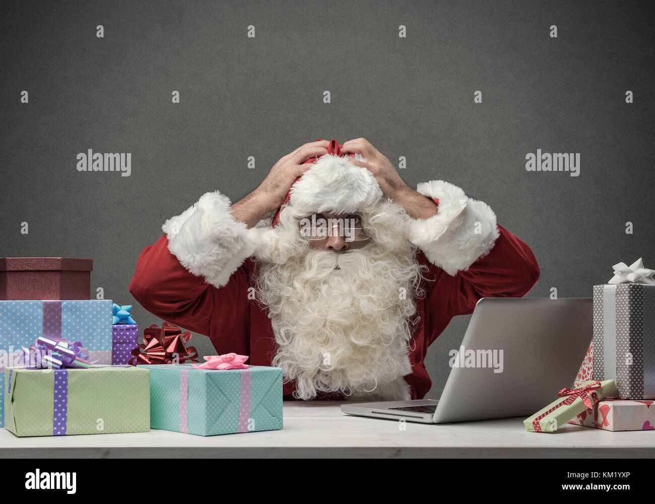 Stressed frustrated Santa Claus with head in hands connecting with his ...