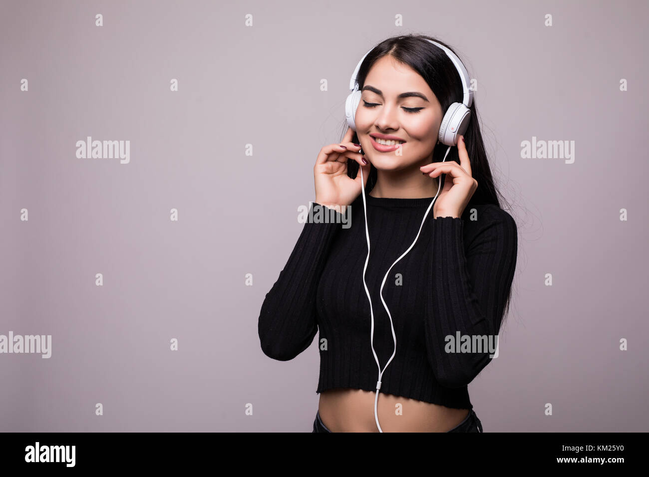 Woman with headphones listening music. Music girl dancing agains white ...