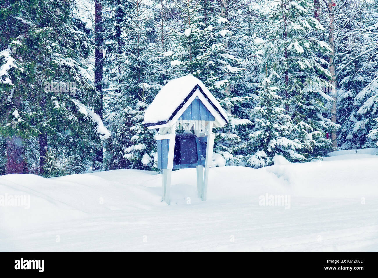 Wooden postbox in winter countryside in Lapland, Finland. At snowfall ...