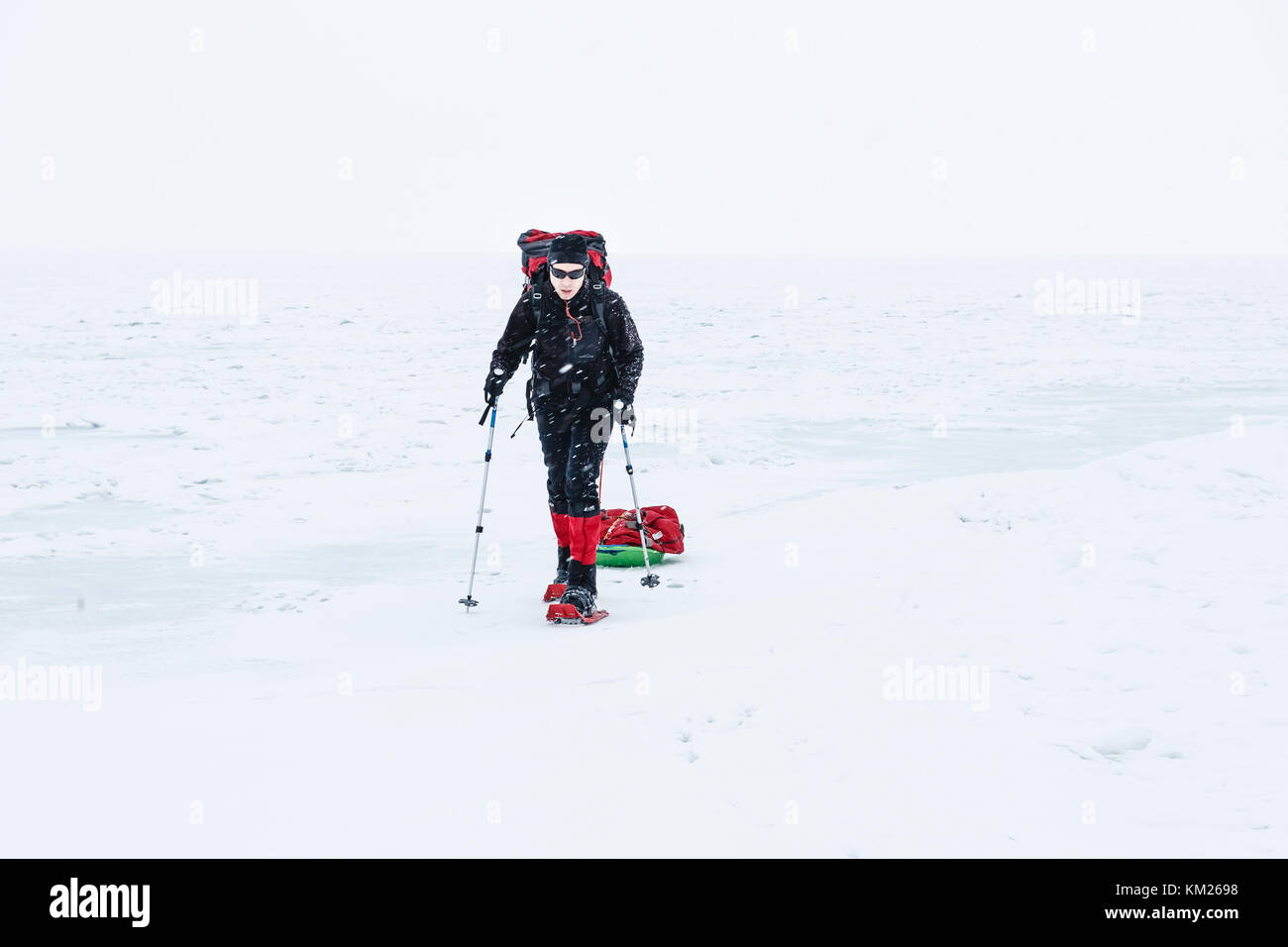 Athlete training for polar mountaineering expedition by pulling sled ...