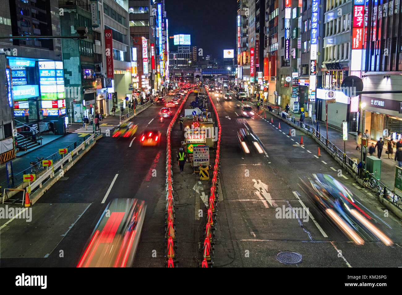 Busy street scene as cars streak by at night in Tokyo, Japan Stock ...
