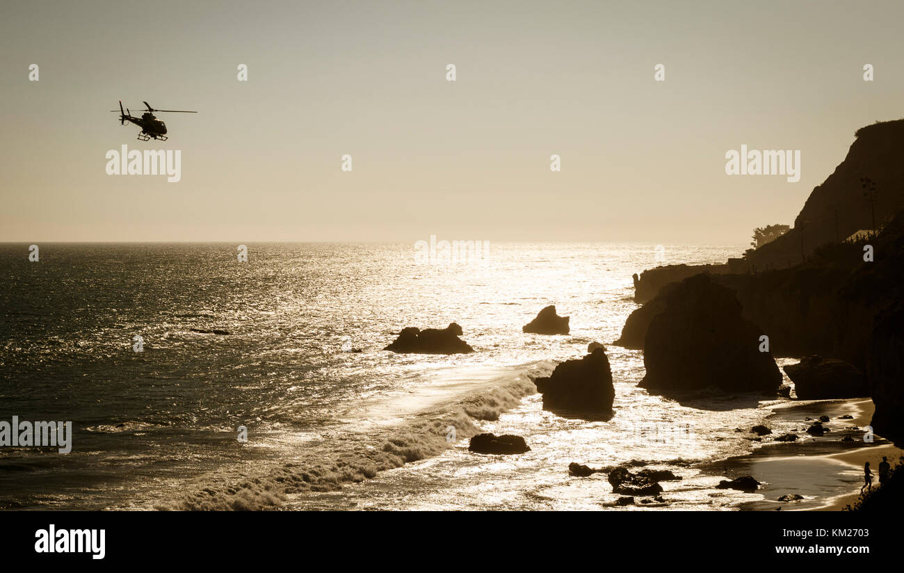 Helicopter flying along the beach, Pacific Coast Highway, California ...