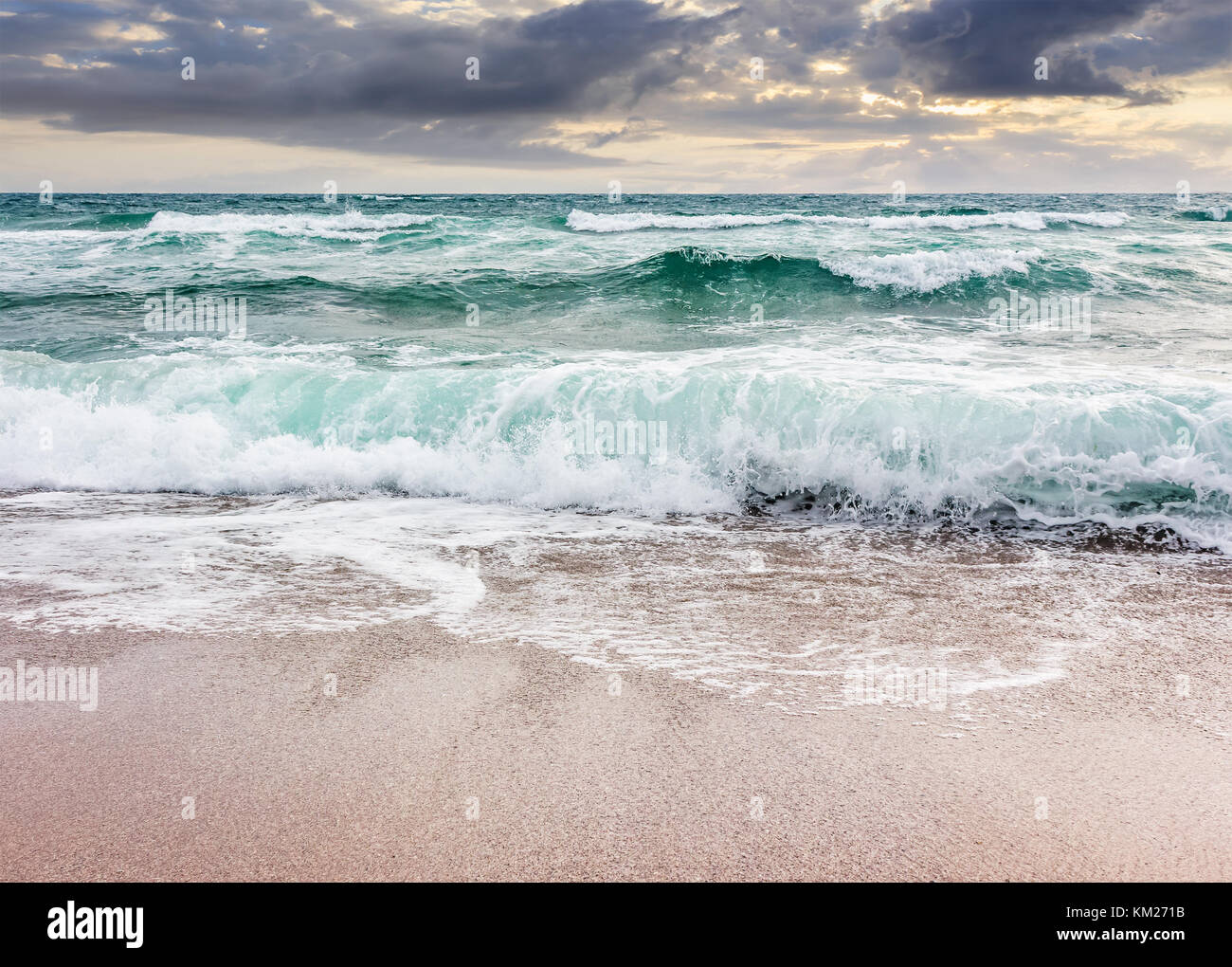 seascape in stormy weather at cloudy sunrise. green waves crashing on ...