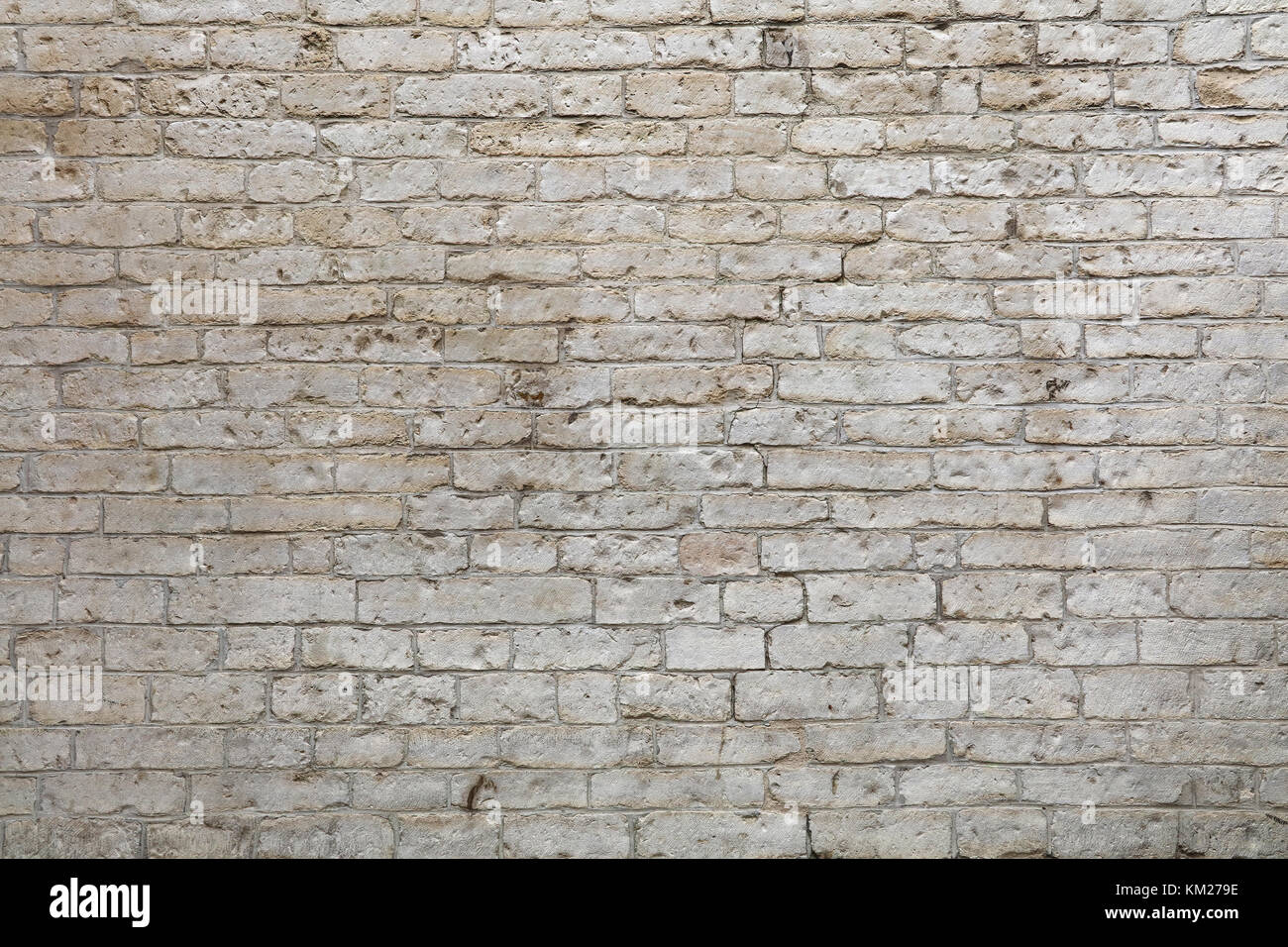 Wall of white and gray weathered limestone travertine stone brick ...