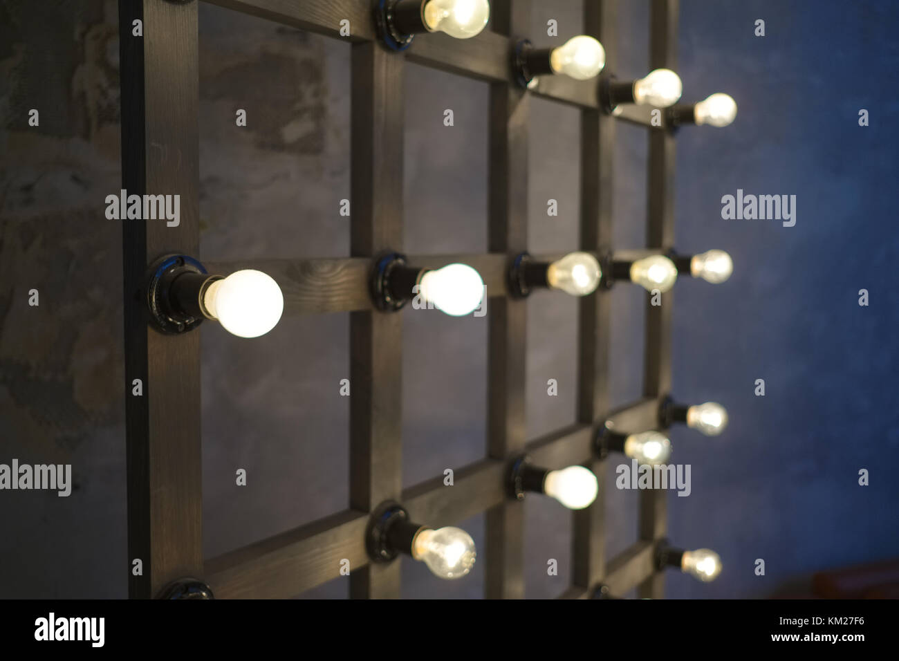 Old edison lamp mounted on wooden background Stock Photo - Alamy