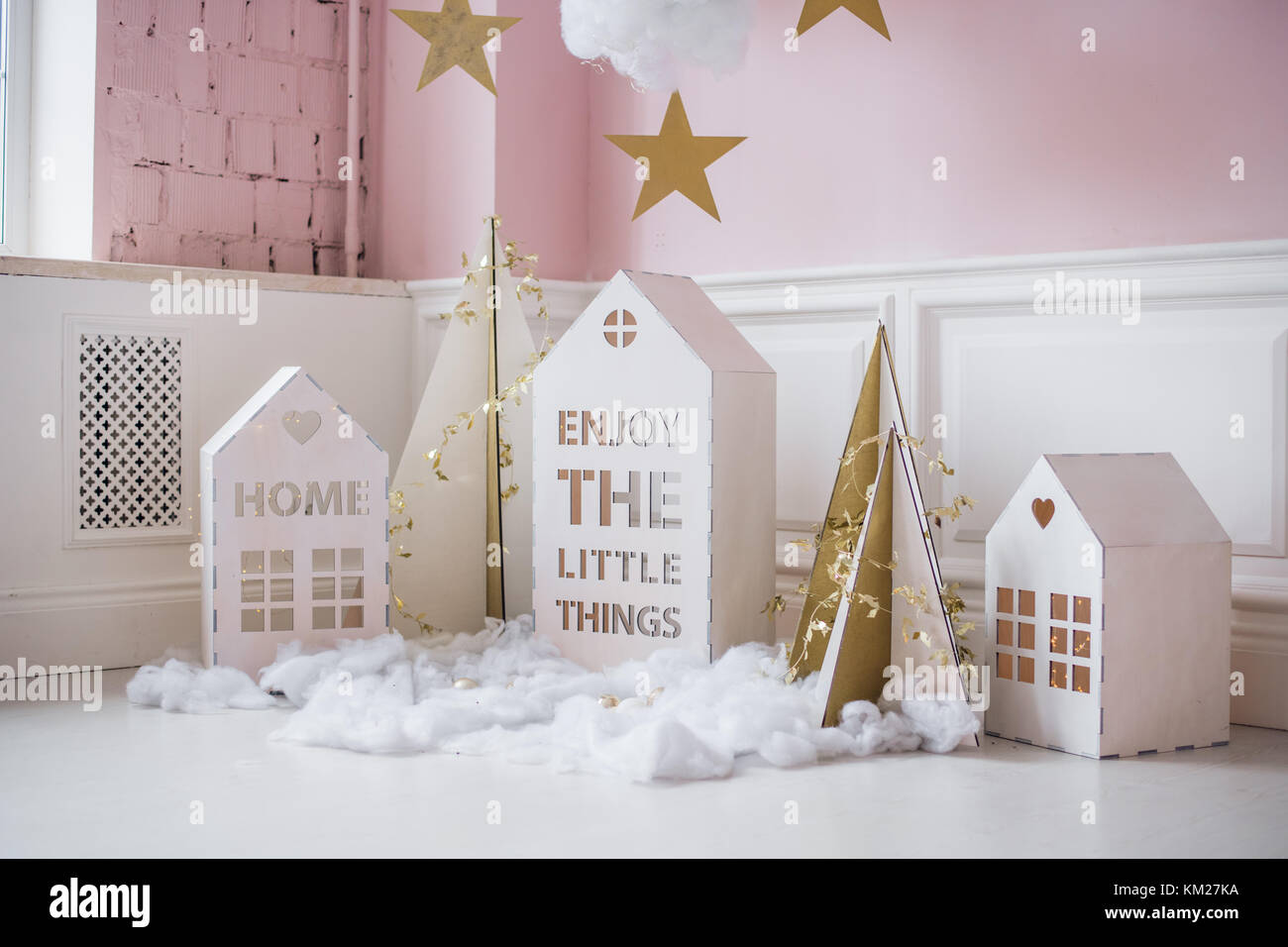 Small christmas houses decoration and stars hanging Stock Photo - Alamy