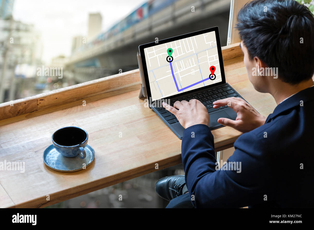 Businessman sitting and using computer laptop showing part of navigator ...