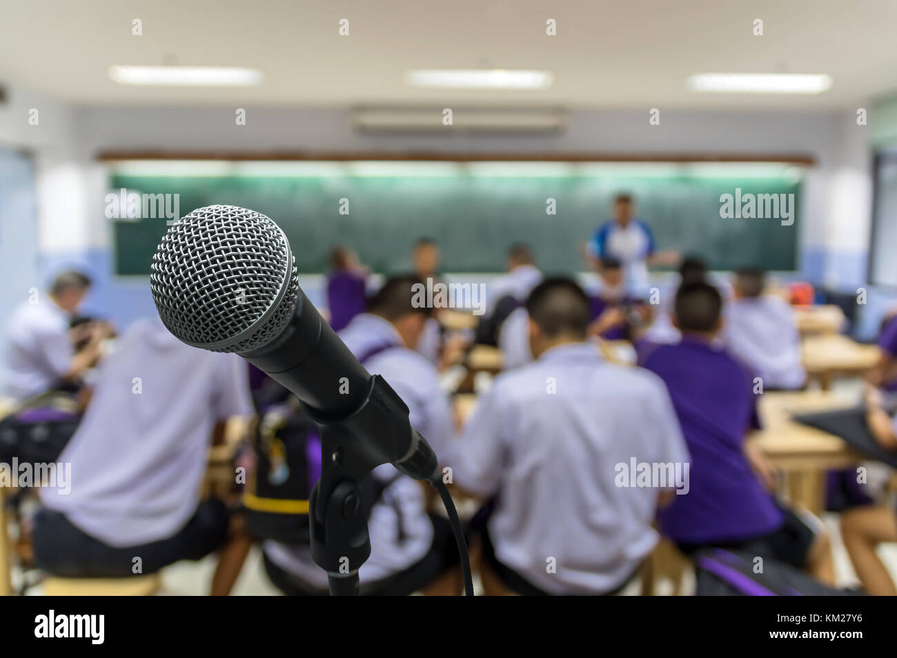 Microphone over the Abstract blurred photo of teacher and study in ...