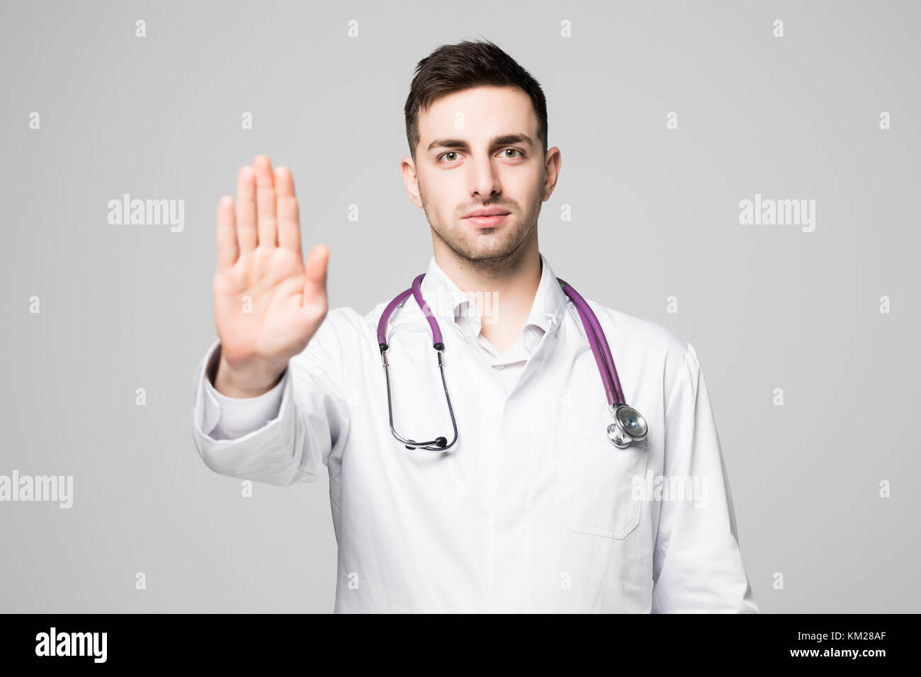 Doctor with stethoscope show off stop or not allowed sign by his hand ...