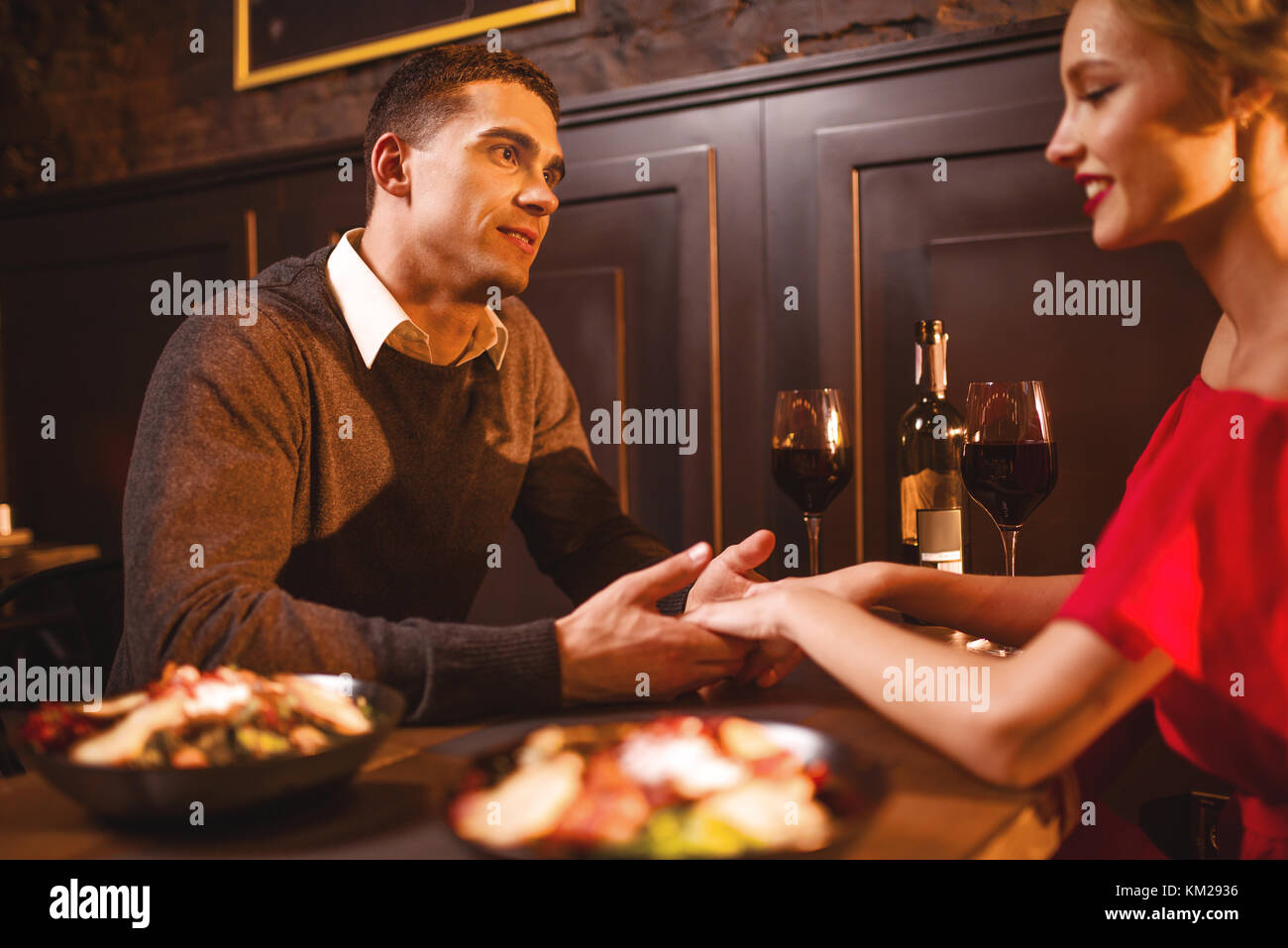 Beautiful love couple in restaurant, romantic evening. Elegant woman in ...