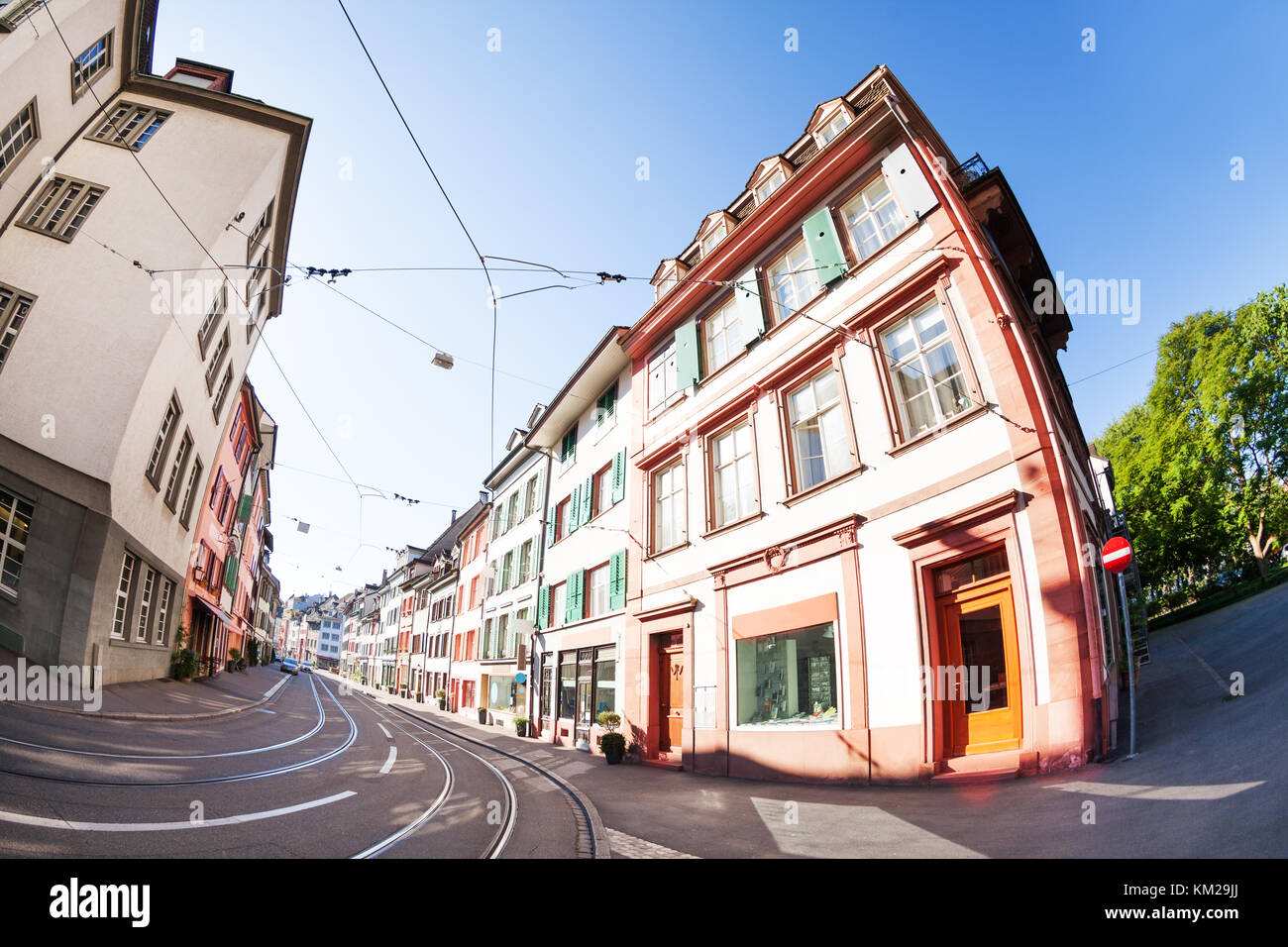 Swiss street scene in downtown Basel with tram tracks, shops and houses ...