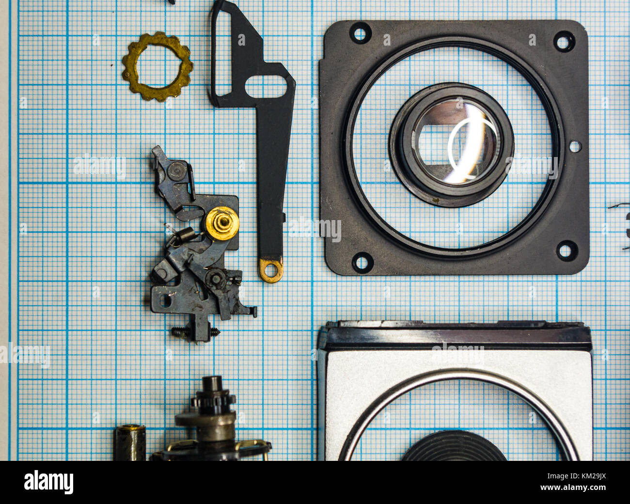 parts are completely disassembled old retro film SLR camera on graph ...