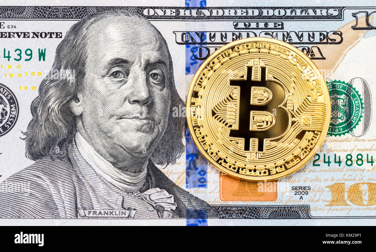 Gold bitcoin lying over one hundred american dollar bill. Business ...