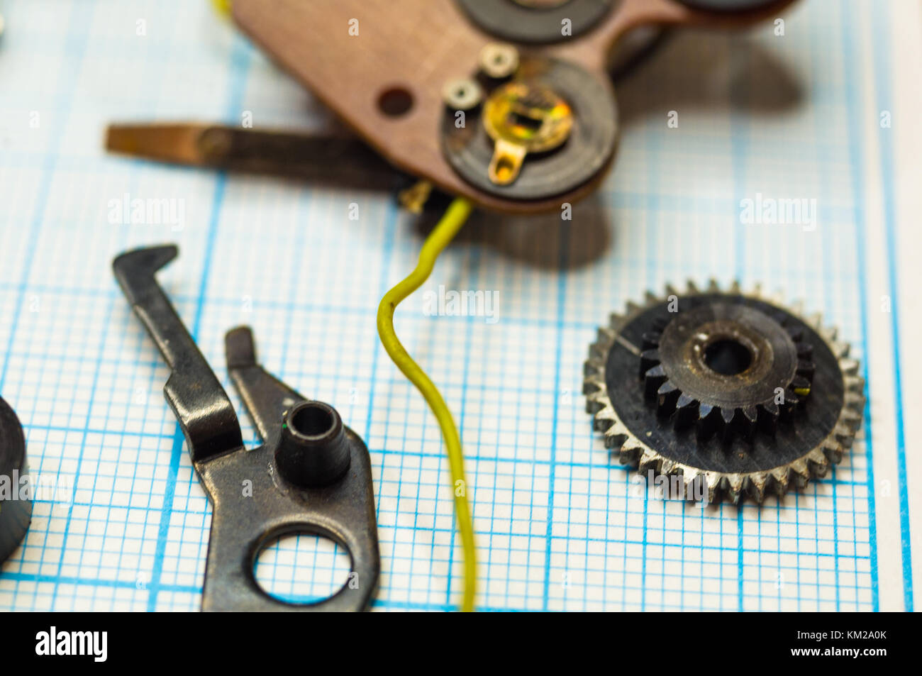 parts are completely disassembled old retro film SLR camera on graph ...