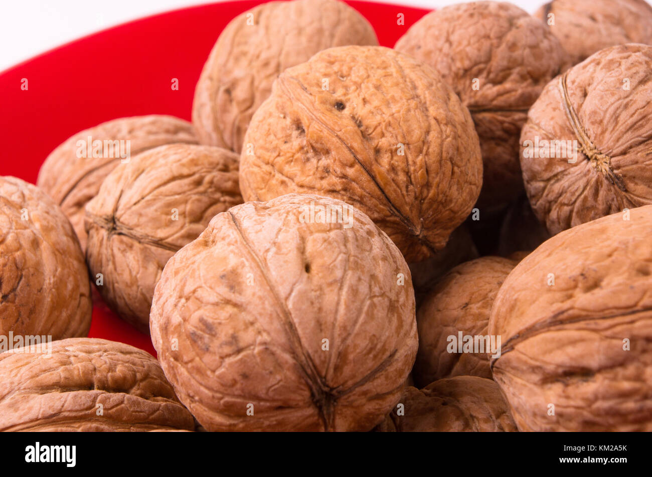 Walnuts in red plate hi-res stock photography and images - Alamy