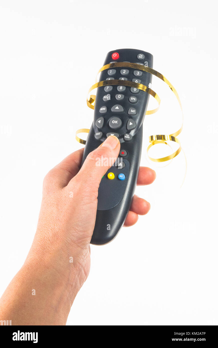 hand holding a remote control in a festive gold ribbon on white ...