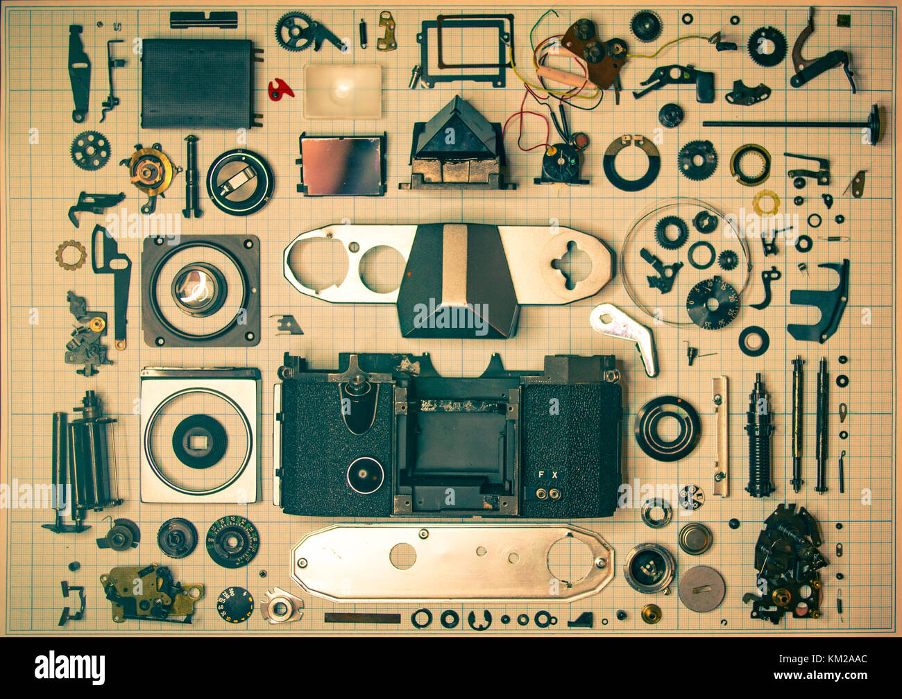 parts are completely disassembled old retro film SLR camera on graph ...