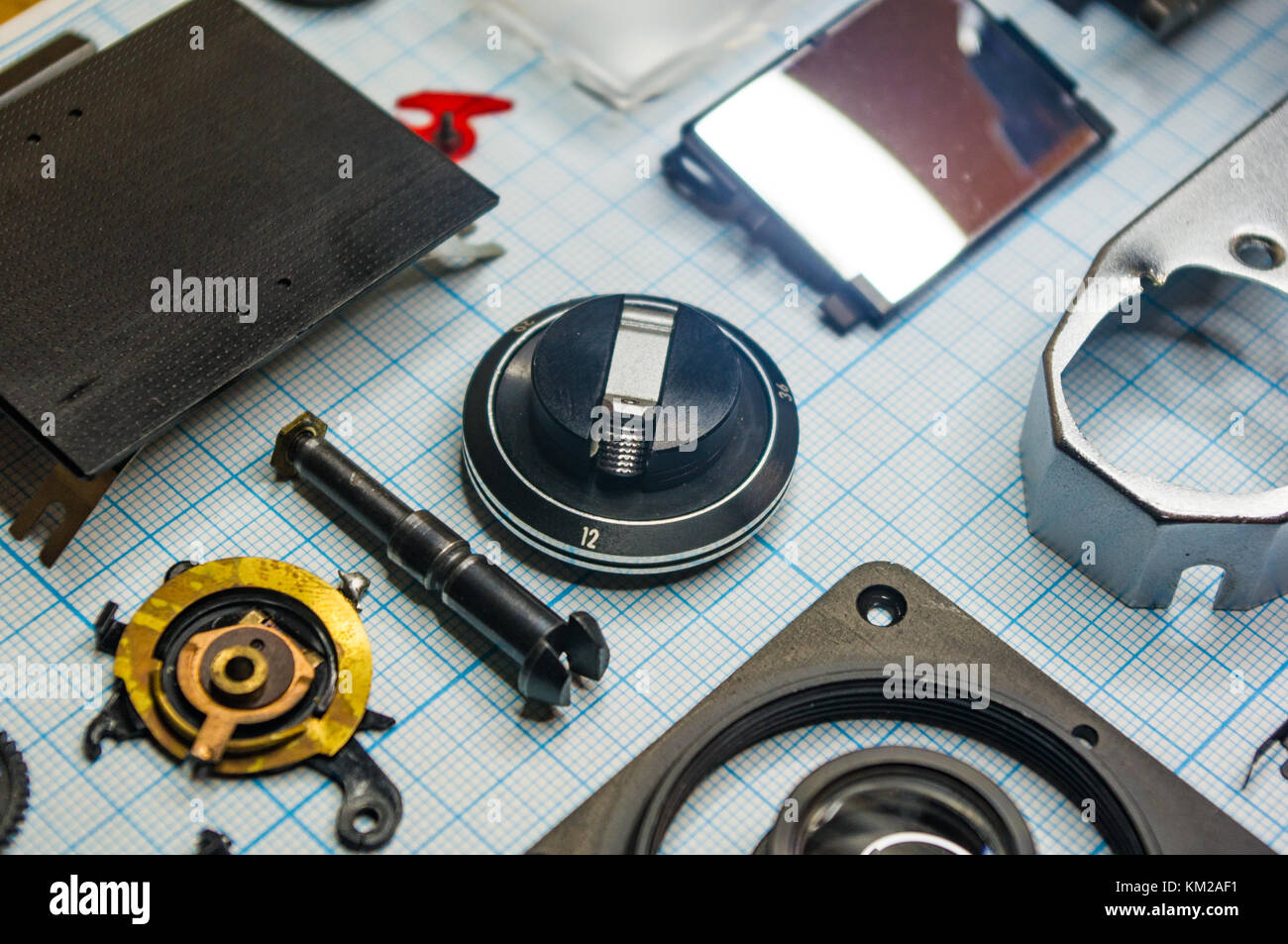 parts are completely disassembled old retro film SLR camera on graph ...