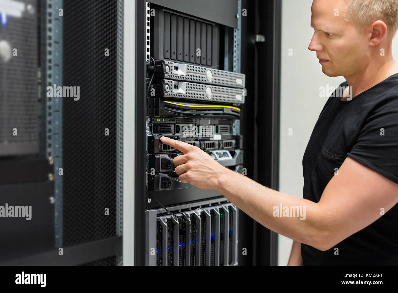 IT Technician Monitors Server On Rack In Datacenter Stock Photo - Alamy