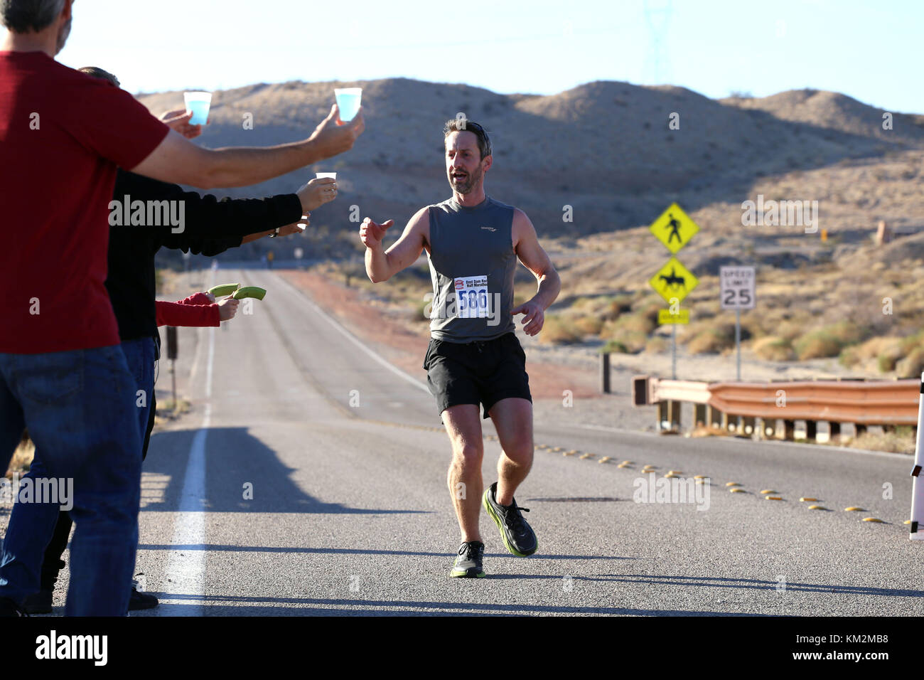 Laughman, Nevada, USA. 2nd Dec, 2017. Runner is running 10k. Water ...