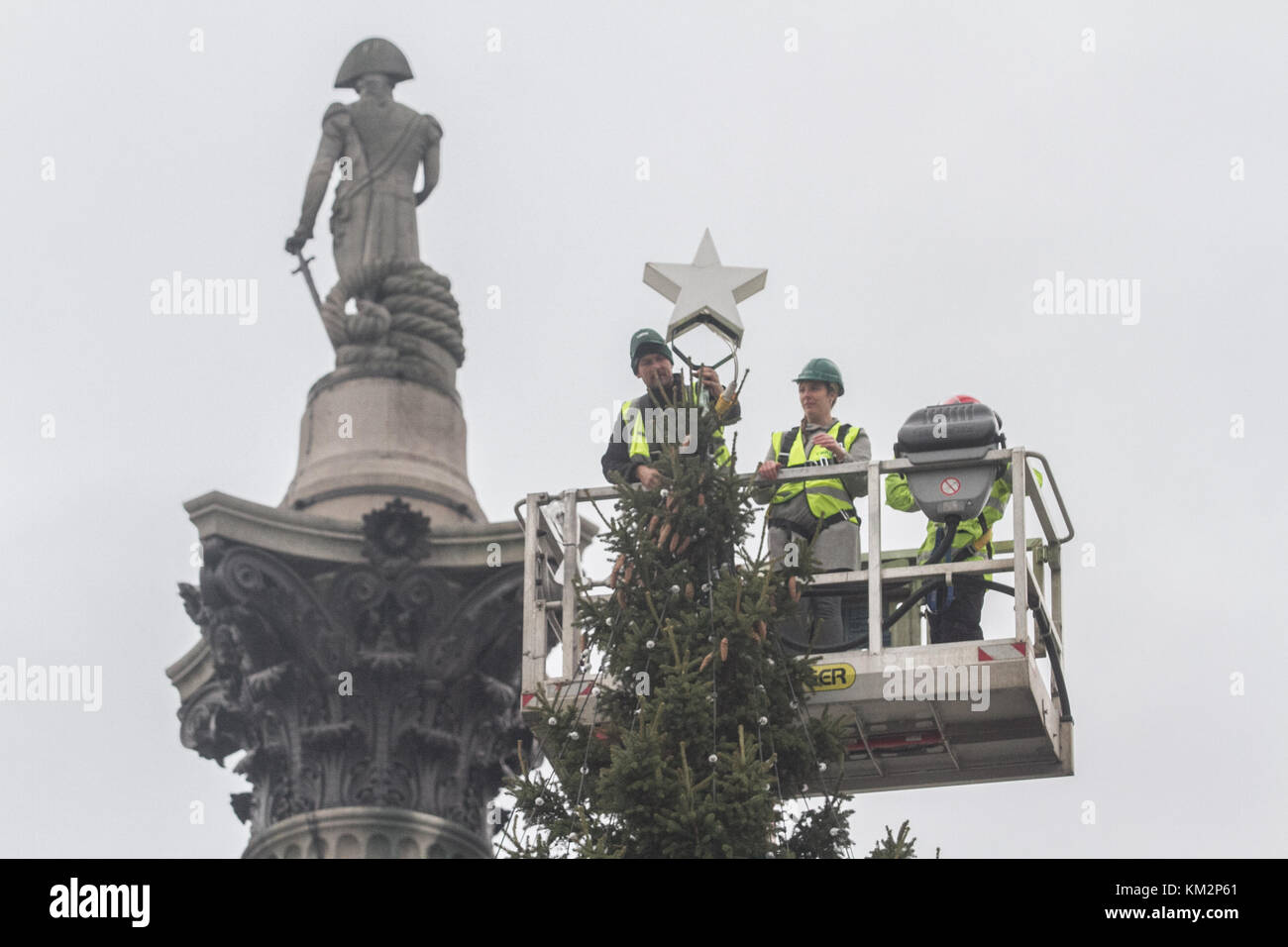 London, UK. 4th Dec, 2017. Workers on a cherry picker place a White ...