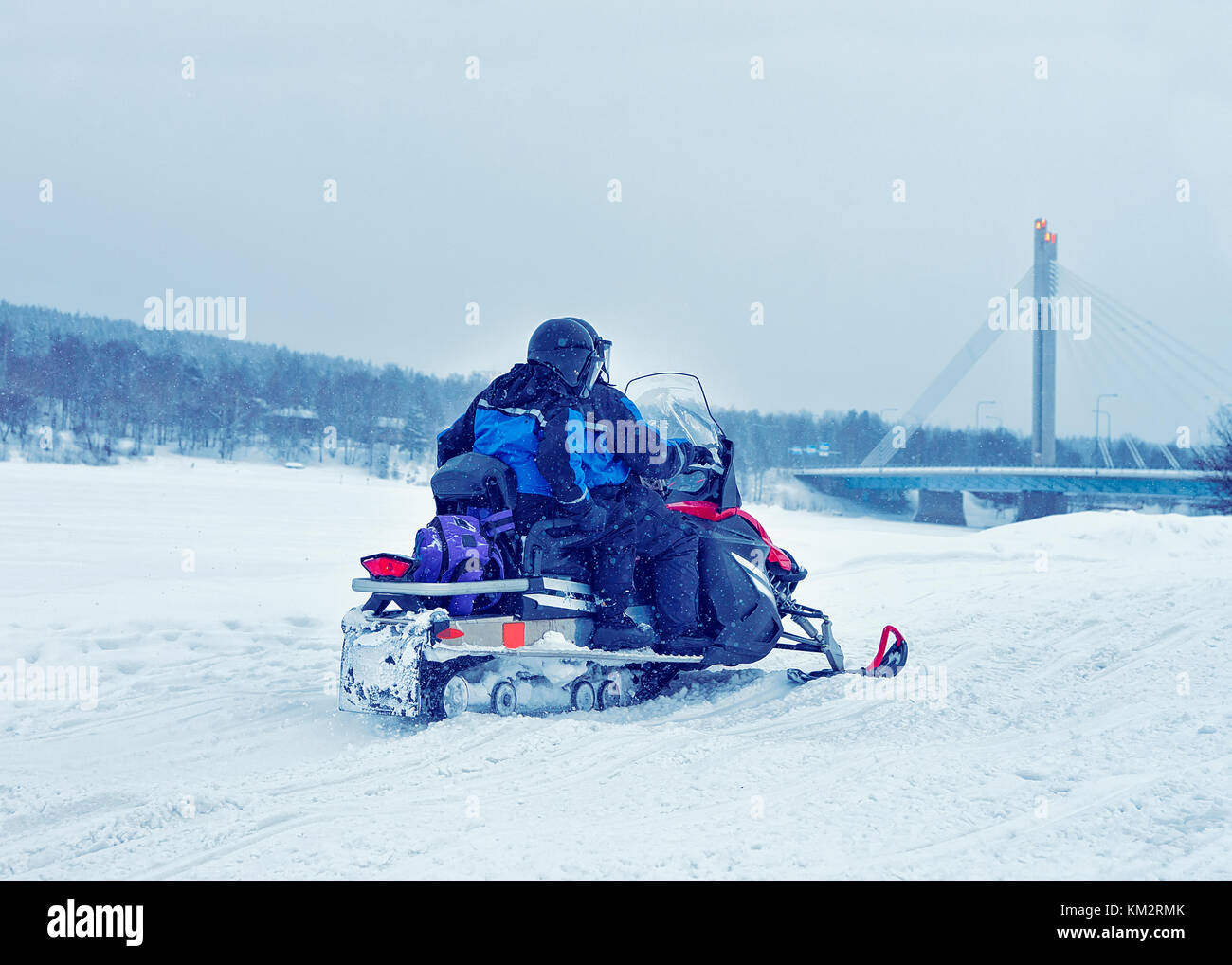 Man and woman riding snowmobile at winter Rovaniemi, Lapland, Finland ...