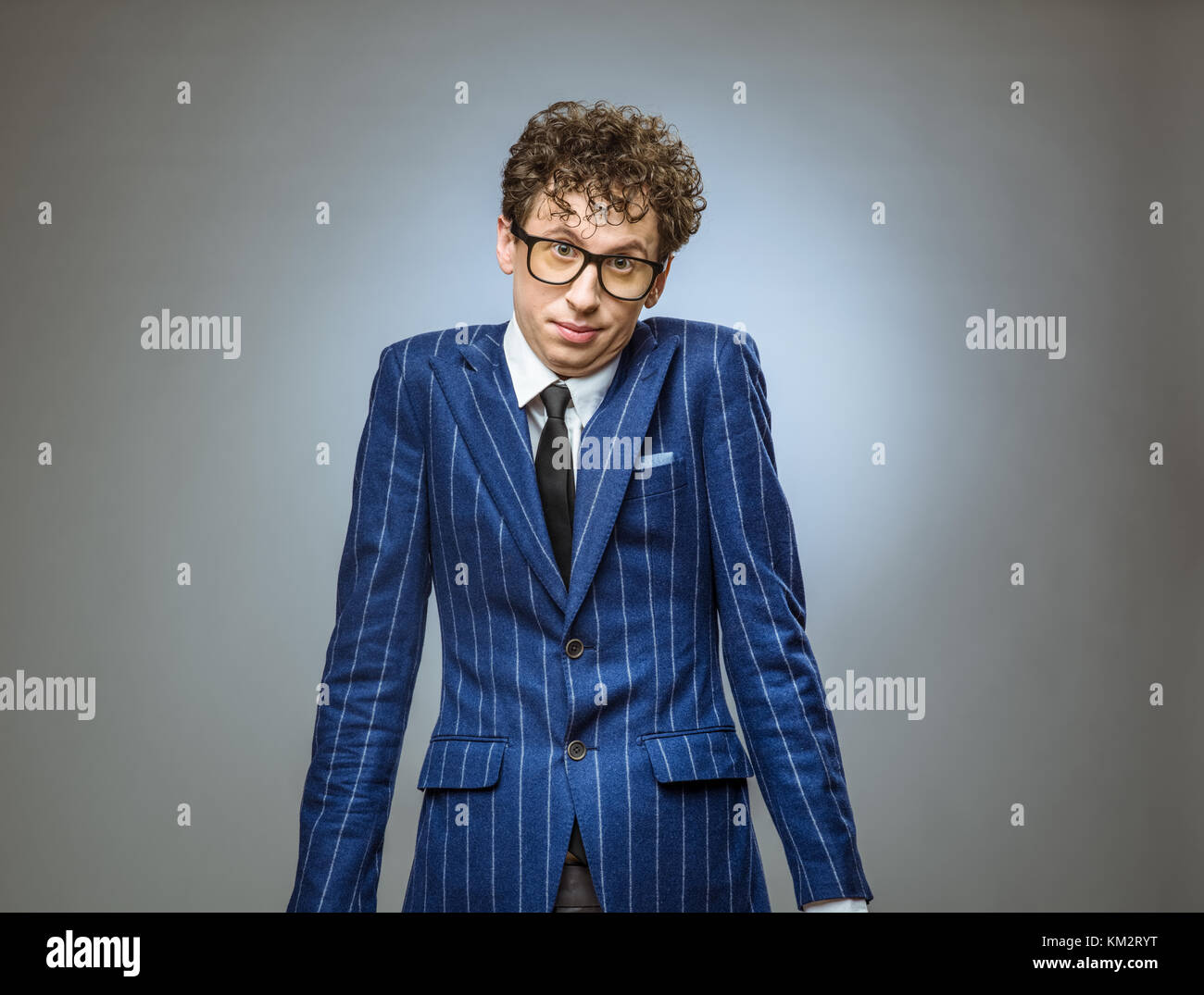 Portrait of confised man giving I dont know gesture on gray background ...